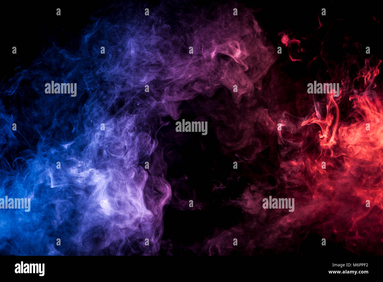 Thick colorful smoke of red, blue on a black isolated background ...