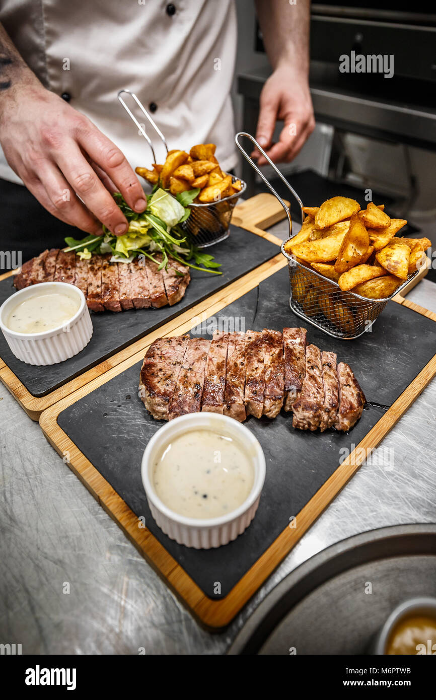 Chef decorating a dish in restaurant kitchen Stock Photo - Alamy