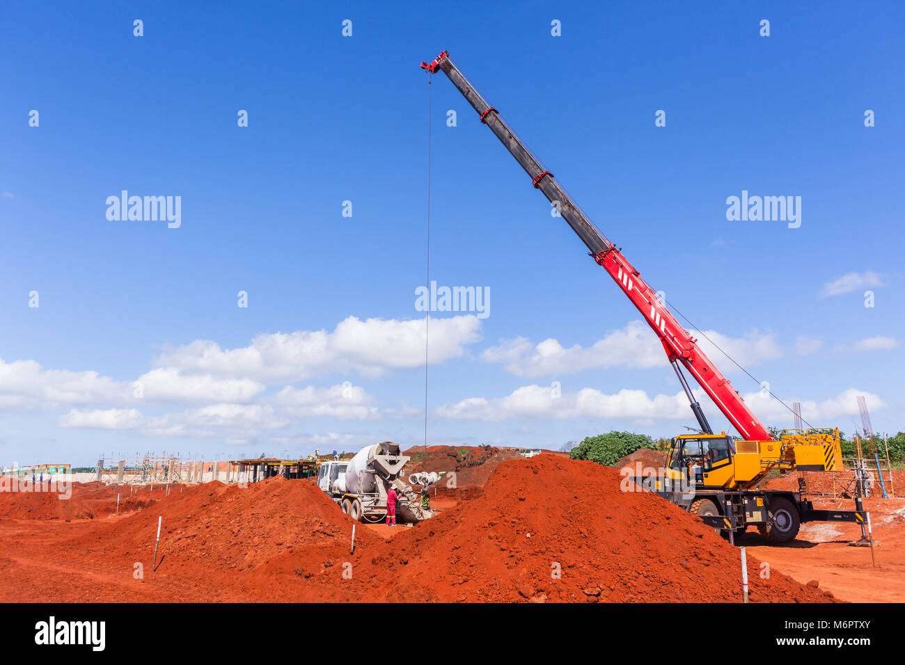 Construction industrial building site mobile crane and concrete truck ...