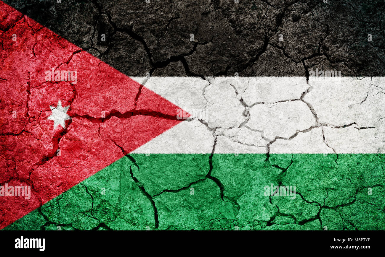 The Hashemite Kingdom of Jordan flag on dry earth ground texture ...