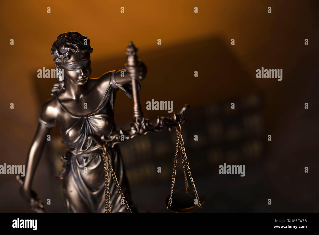 Law symbols on brown background. Books and statue of justice Stock ...