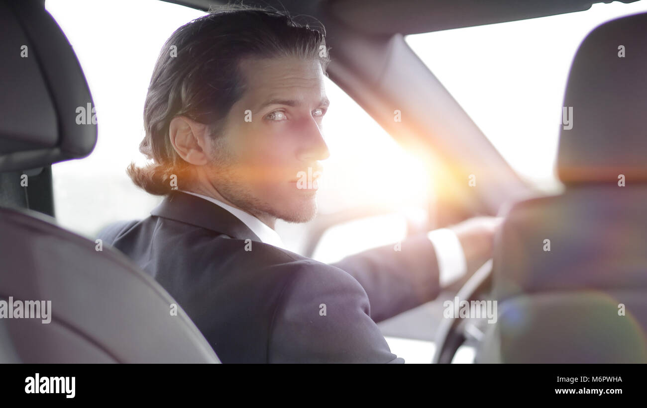 man sitting behind the wheel of a car Stock Photo - Alamy
