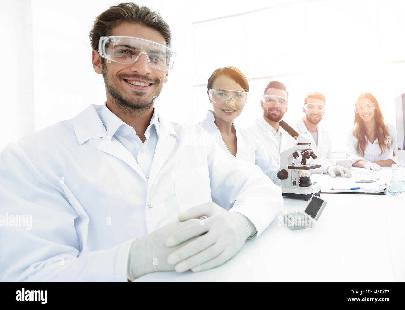 Male scientist and the team in the lab Stock Photo - Alamy