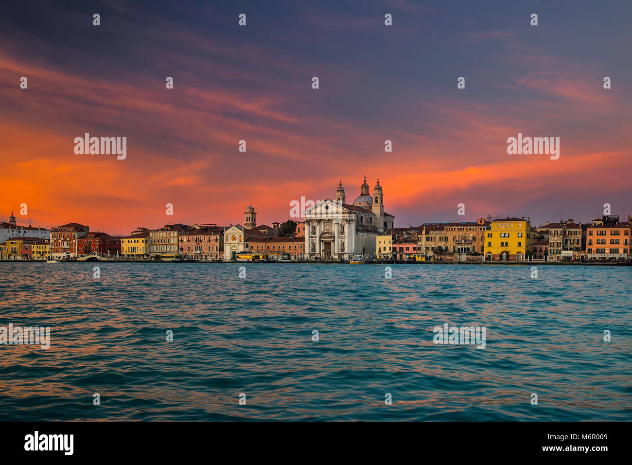 A charming view of Venice's waterfront with palaces and houses in the ...