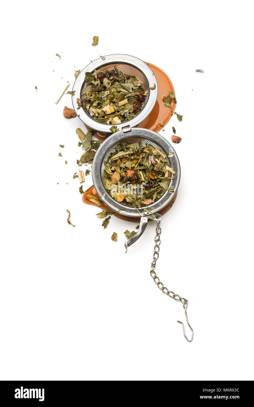 wet tea infuser opened on white table with herbal mixture for tea Stock ...