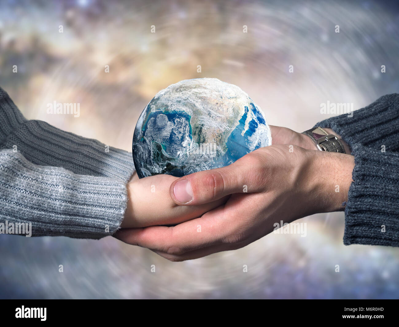 Freezing planet Earth. Hands of an adult and a child. The concept of ...