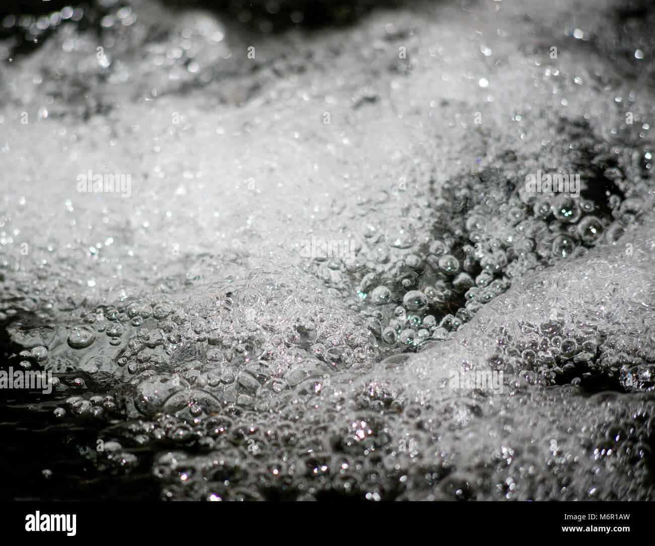 Close up shot of foam on water Stock Photo - Alamy