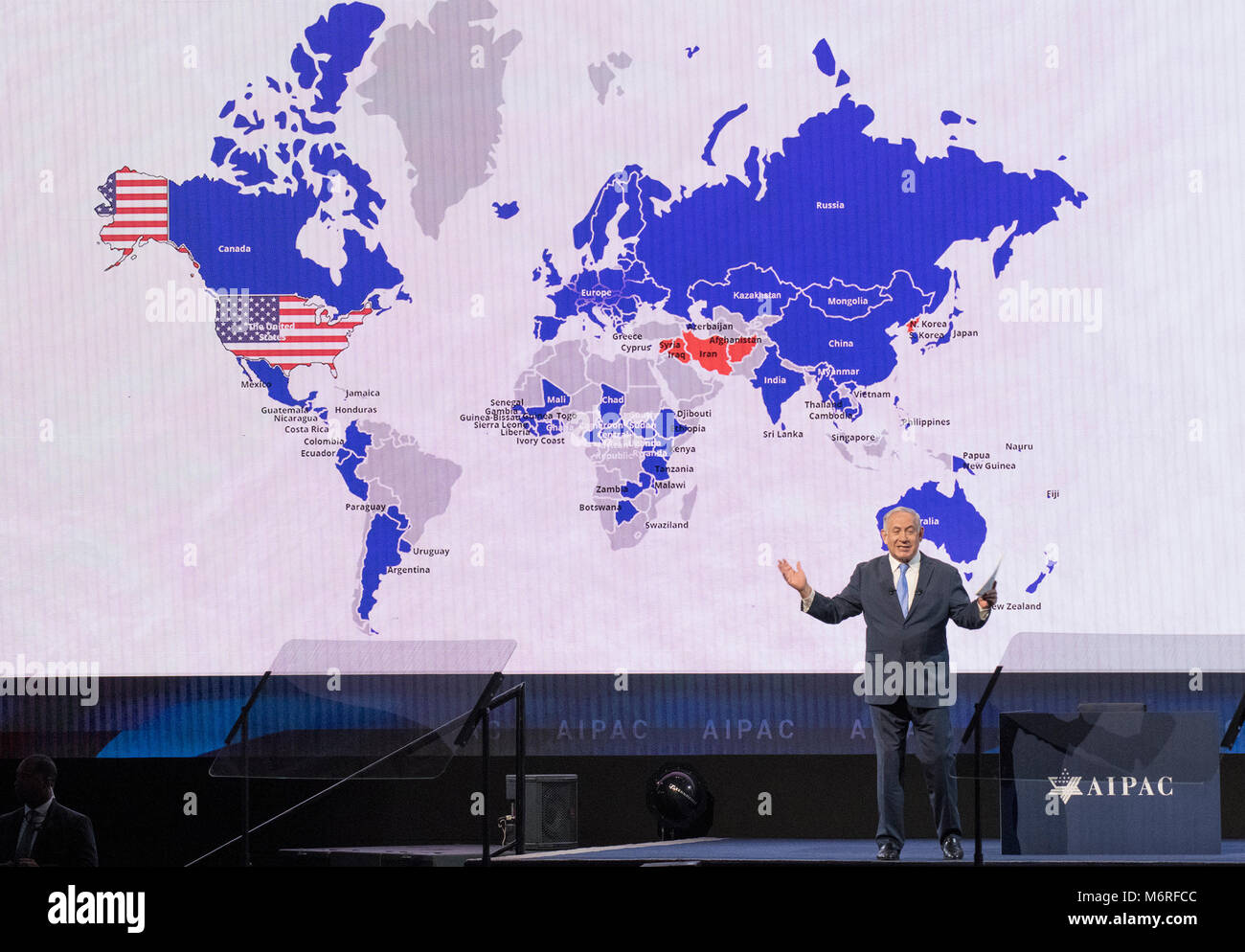 Prime Minister Benjamin Netanyahu of Israel stands in front of a chart ...