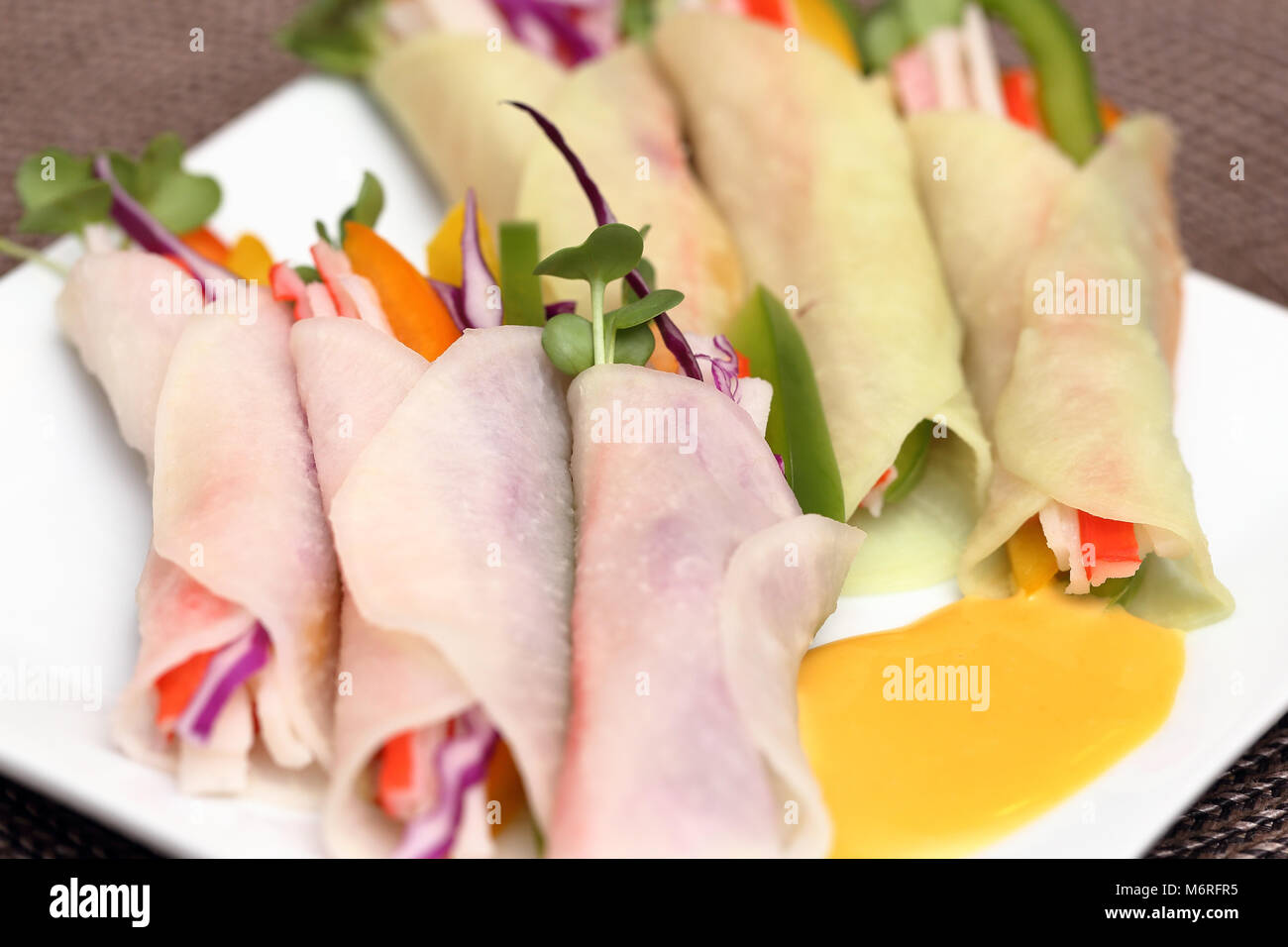 Home-made Korean pickled radish wraps with mustard source Stock Photo ...