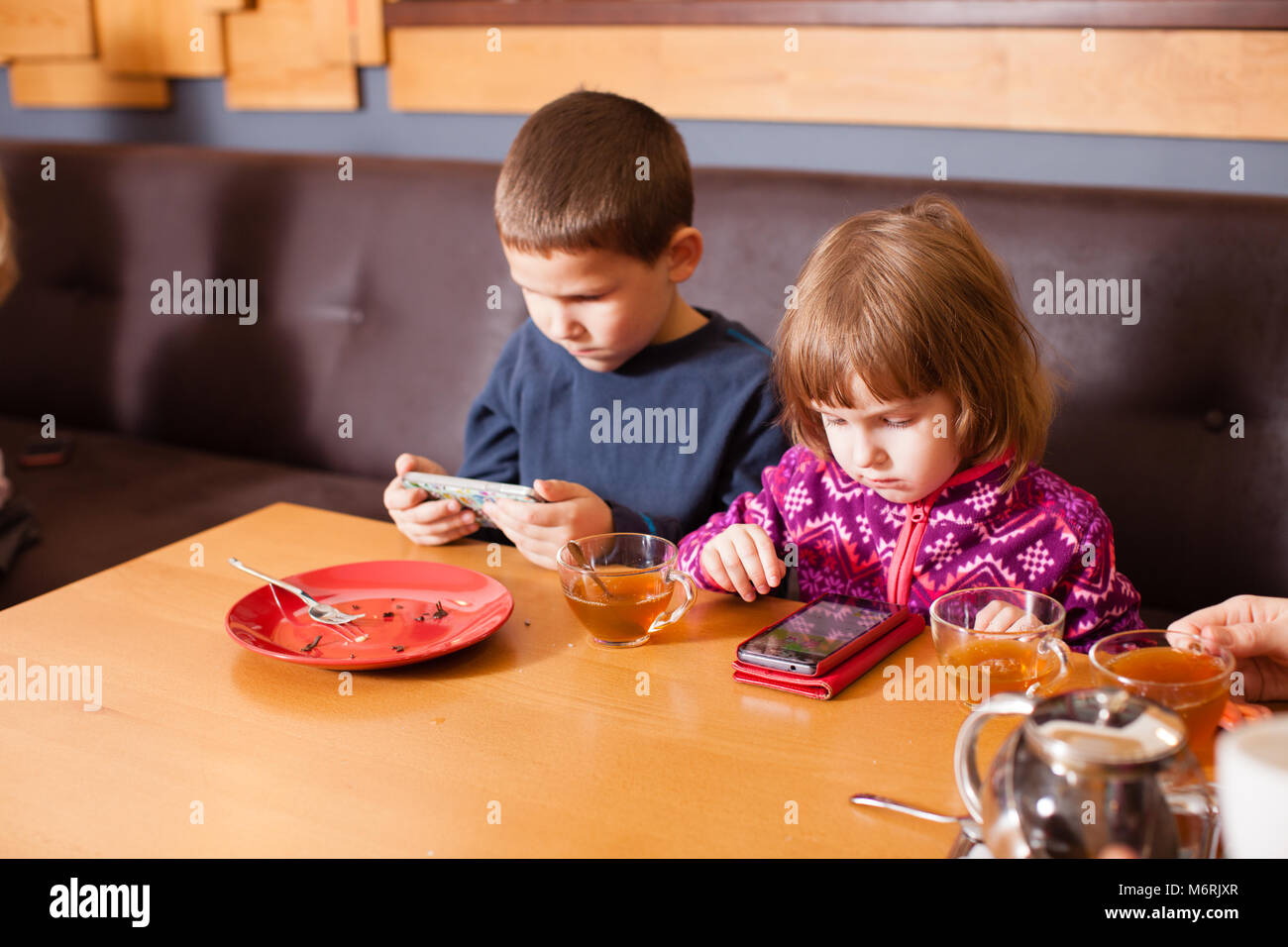 The children at the table Stock Photo - Alamy