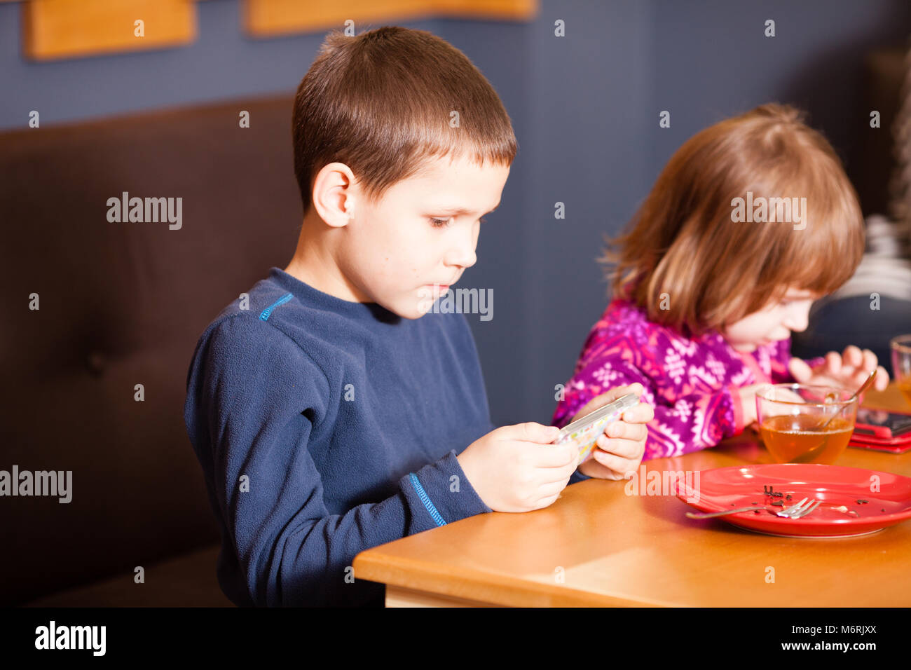 The children at the table Stock Photo - Alamy