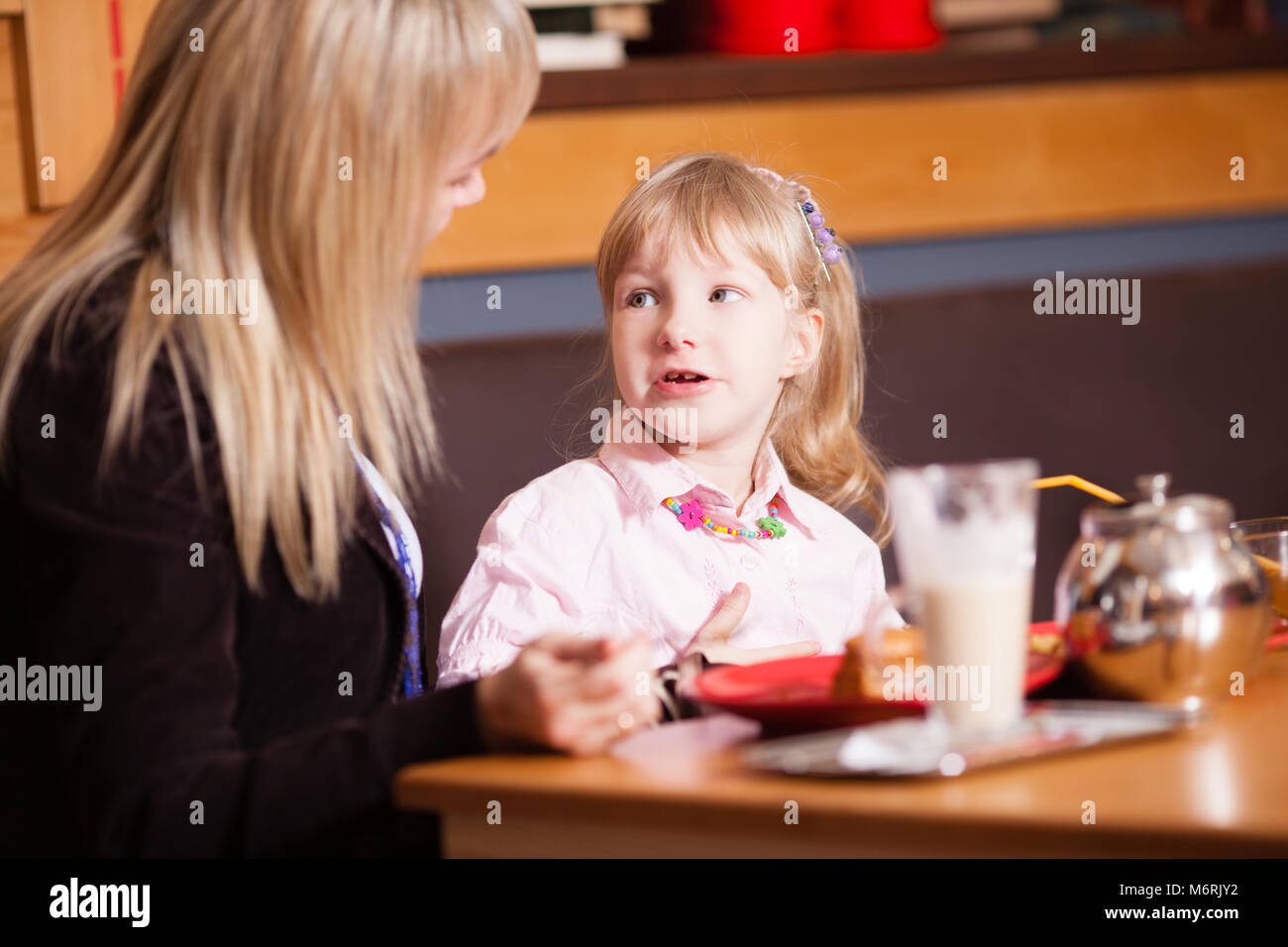 Mom and daughter enjoying life in the cafe Stock Photo - Alamy