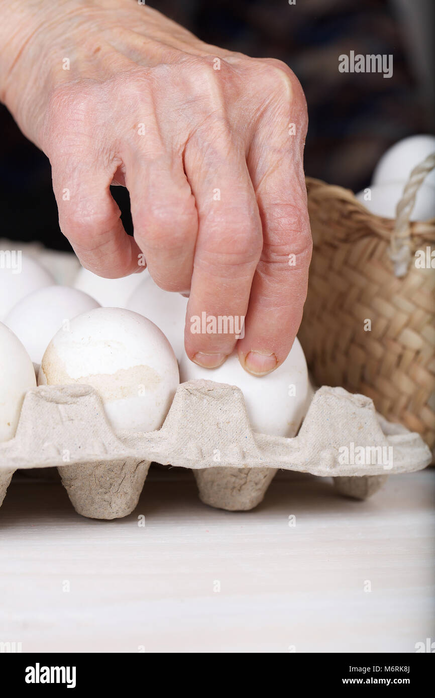 Old woman and fresh chicken eggs.Closeup Stock Photo - Alamy