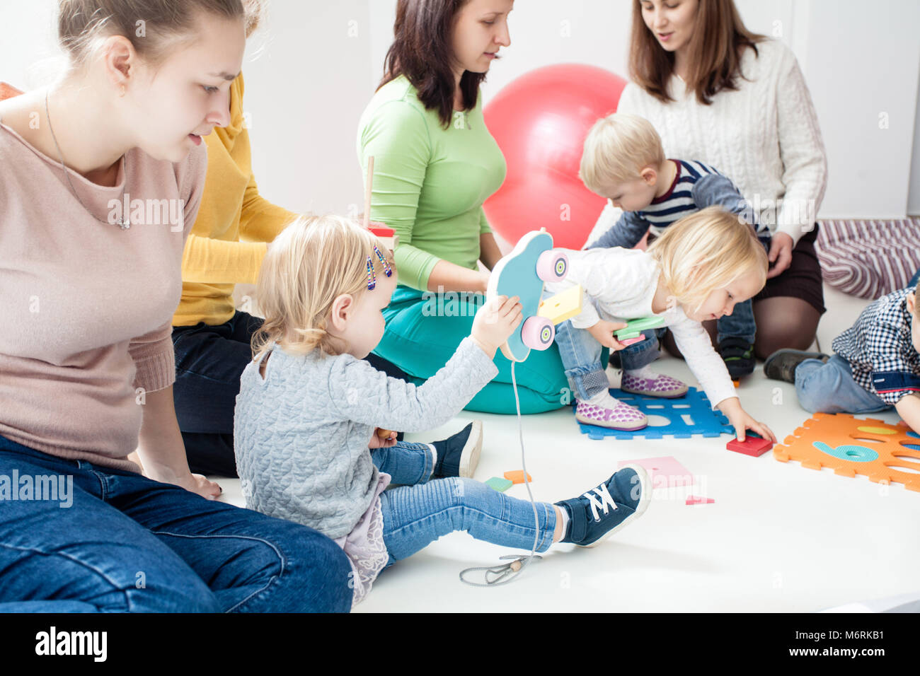 Young moms with their kids Stock Photo - Alamy
