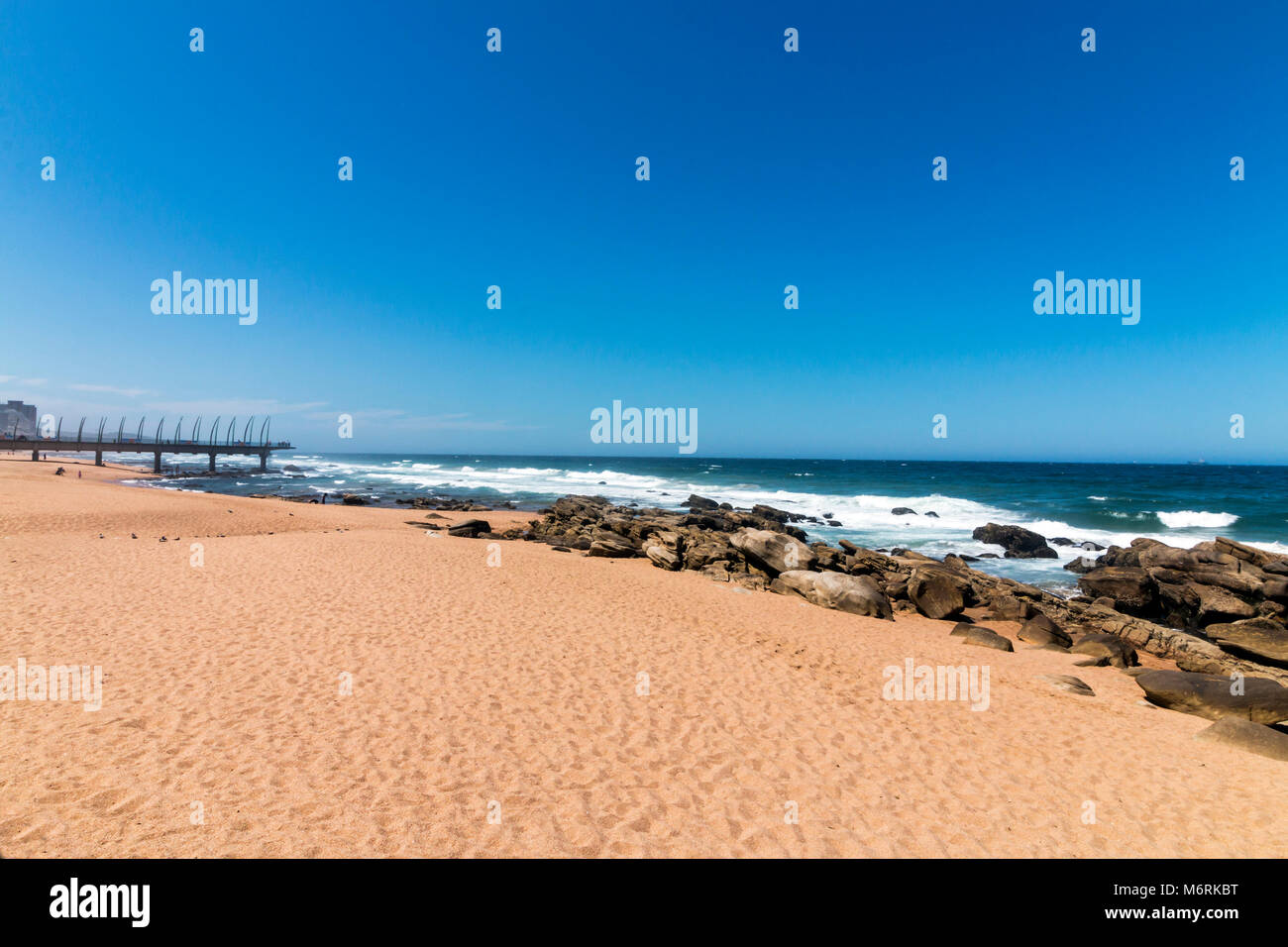 Empty Umhlanga Rocks beach and sea against blue sky coastal landscape ...
