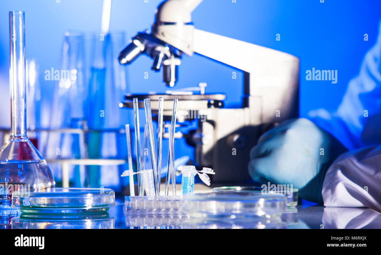 Doctor doing research using microscope hi-res stock photography and ...