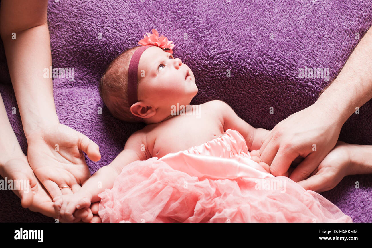 Parents support their baby Stock Photo - Alamy