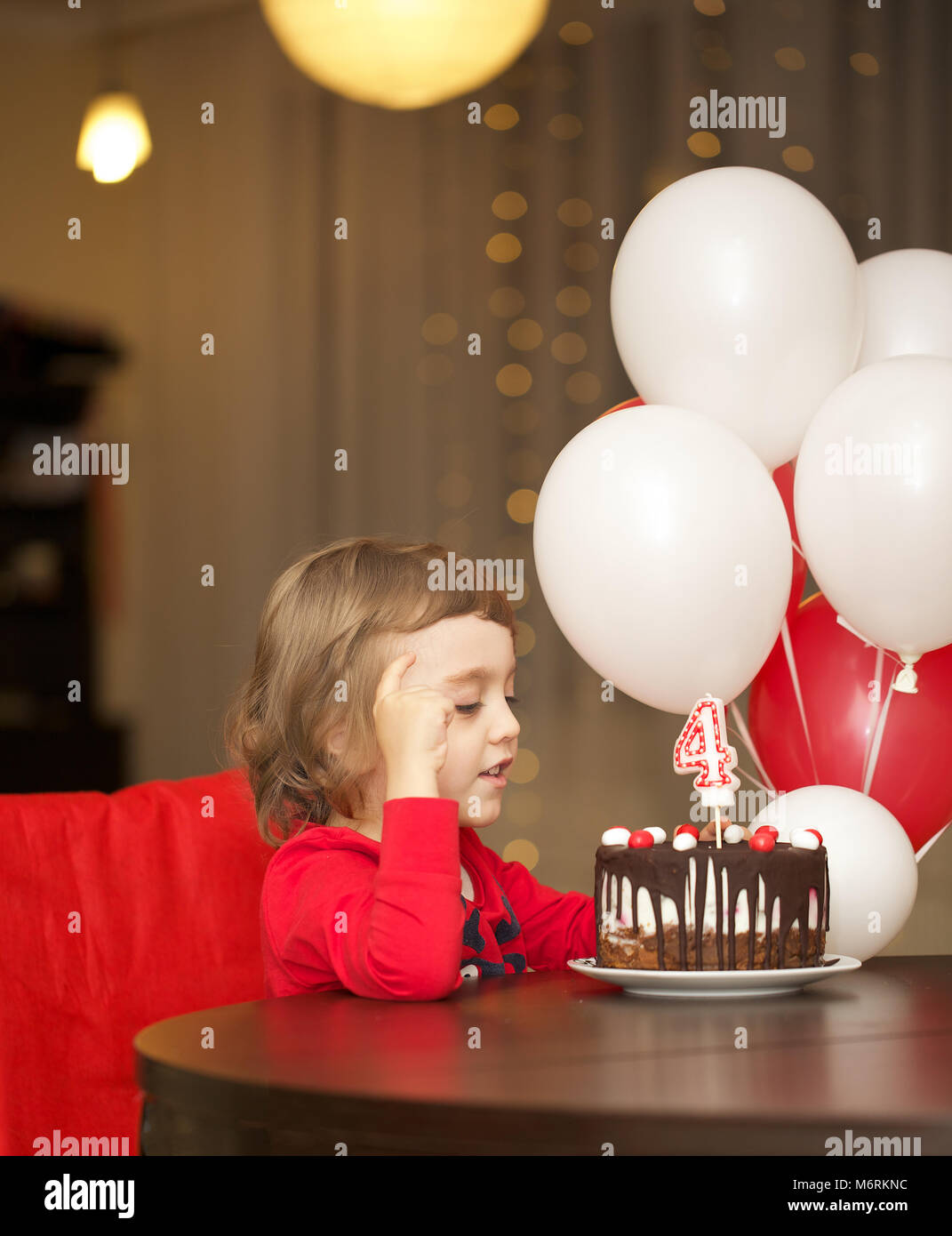 Boy with long hair has his 4th birthday Stock Photo - Alamy