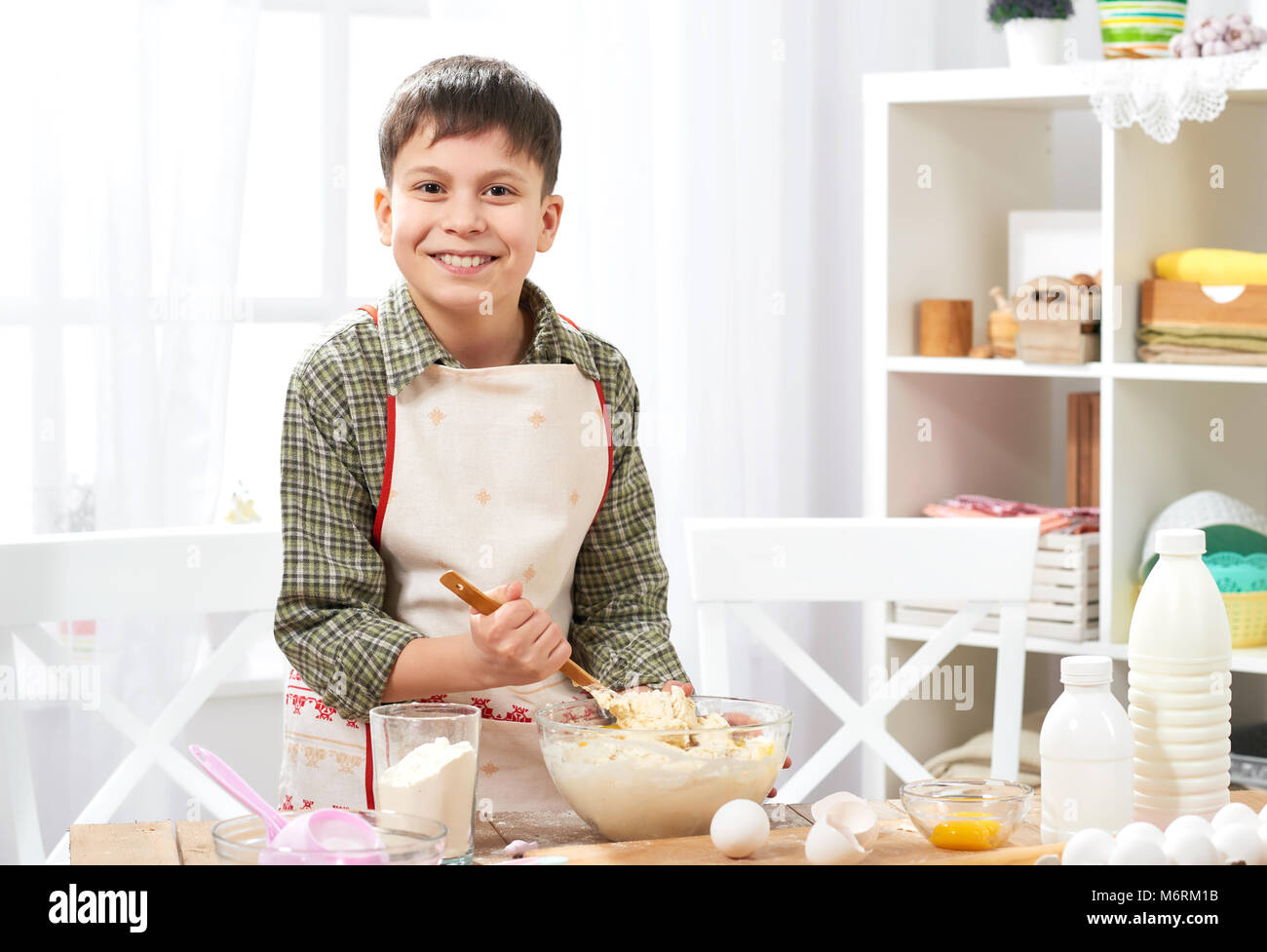 Boy cooking at home, making dough, buns and cookies Stock Photo - Alamy