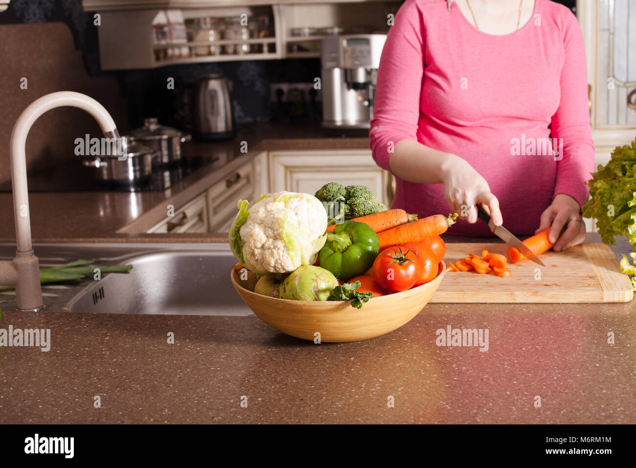 Pregnant woman is cooking Stock Photo - Alamy