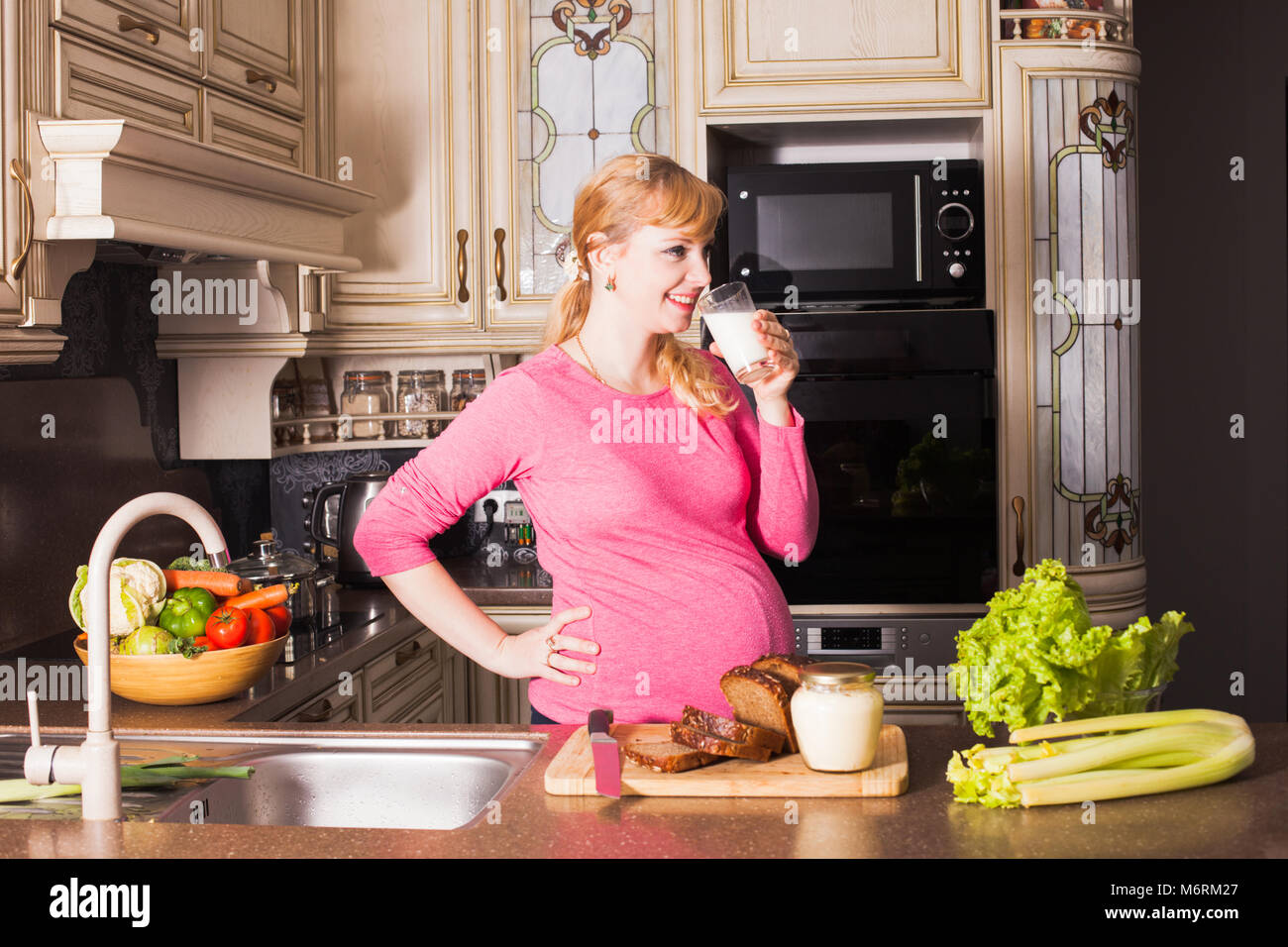 Pregnant woman is cooking Stock Photo - Alamy