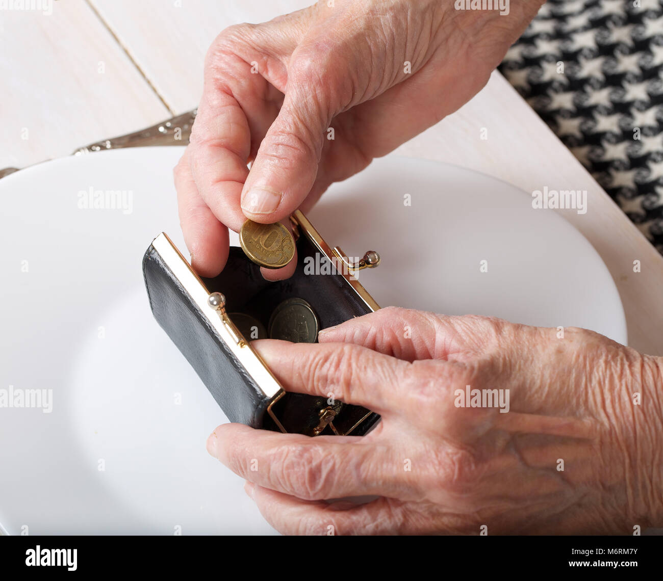 Old woman shows her wallet with coins Stock Photo - Alamy