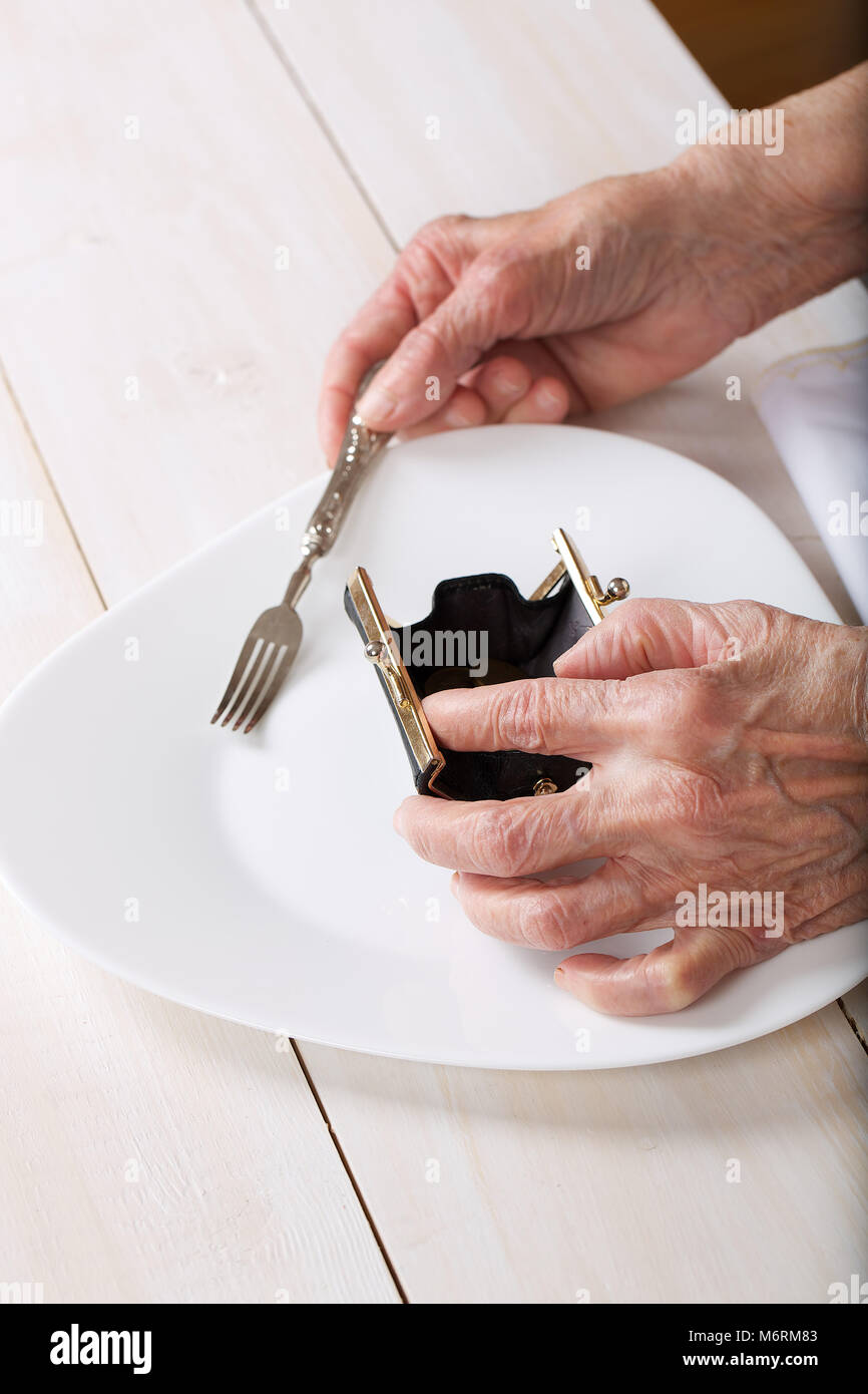 Old woman shows her empty lunch plate Stock Photo - Alamy