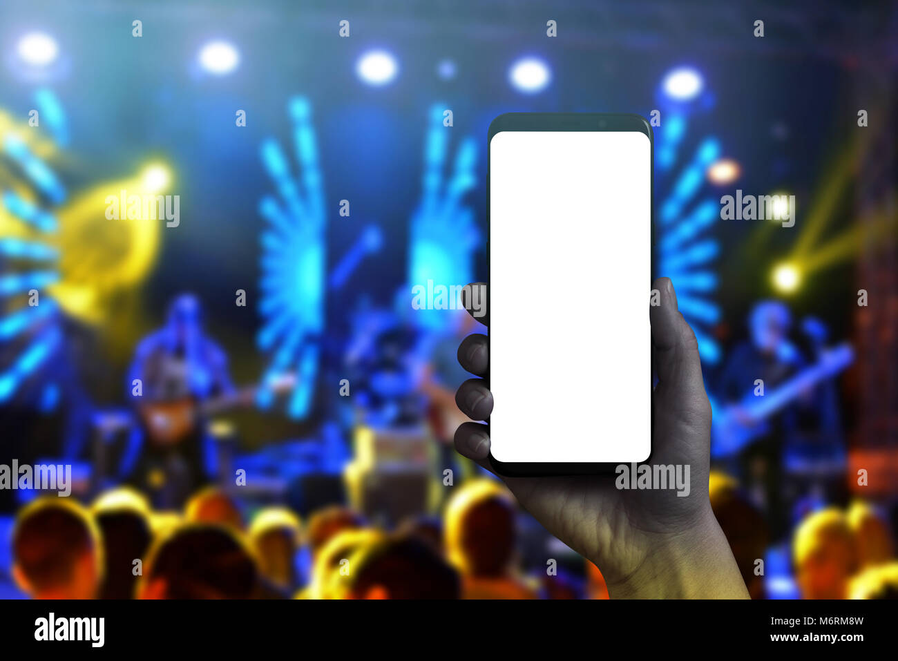 Phone during a concert in the hands of the audience. Isolated display ...