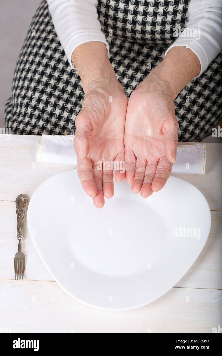 Old woman shows her empty lunch plate Stock Photo - Alamy