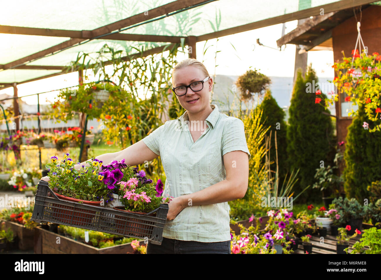 Happy gardener with plant Stock Photo - Alamy