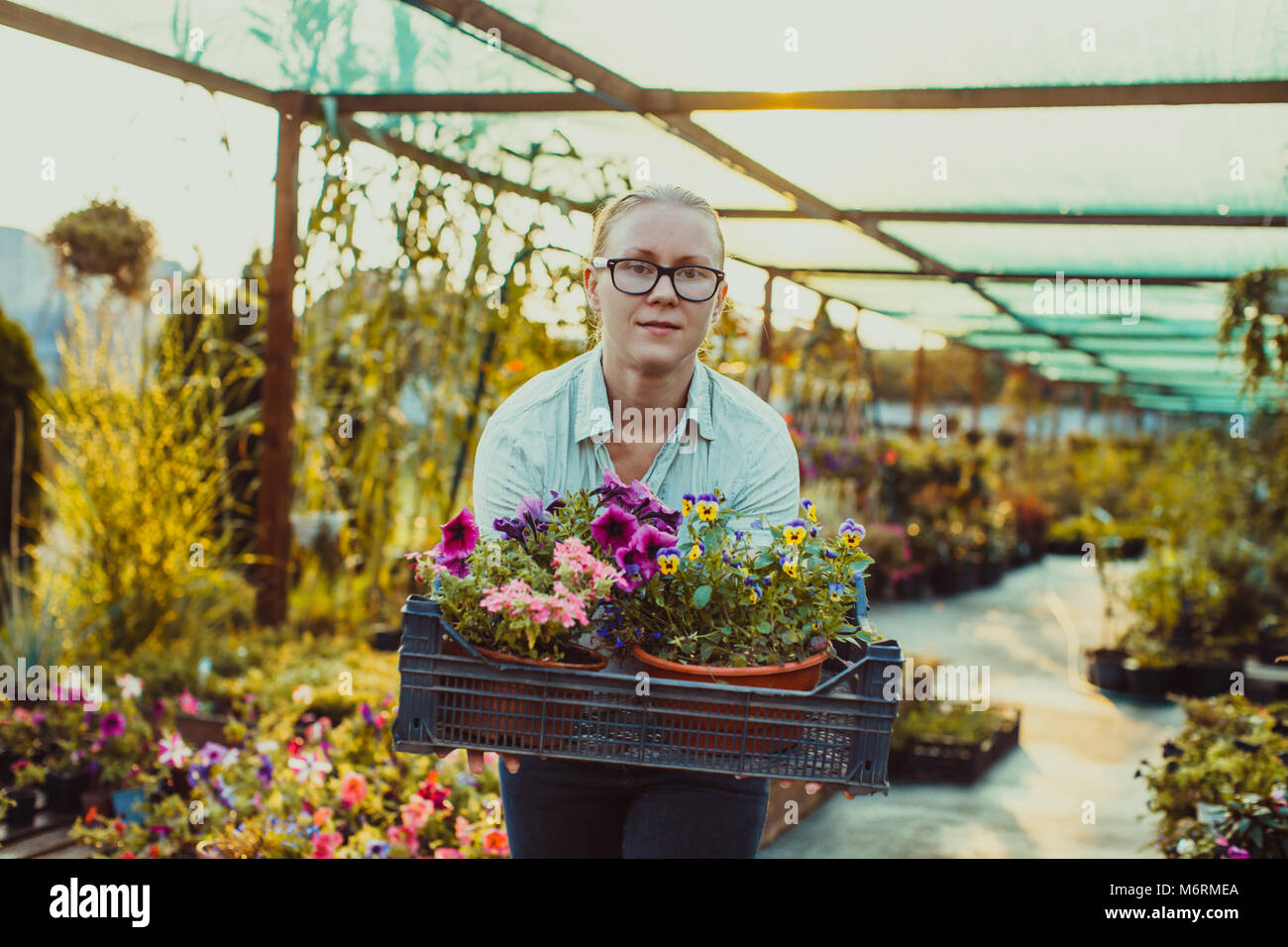 Happy gardener with plant Stock Photo - Alamy