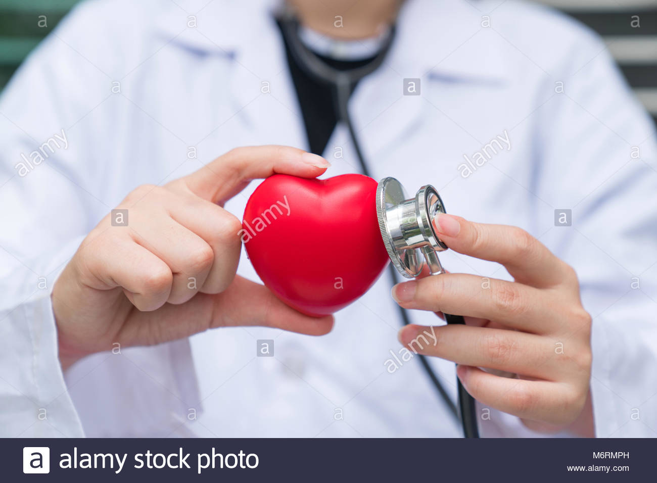 A Doctor With Stethoscope Examining Heart Stock Photos & A Doctor With ...