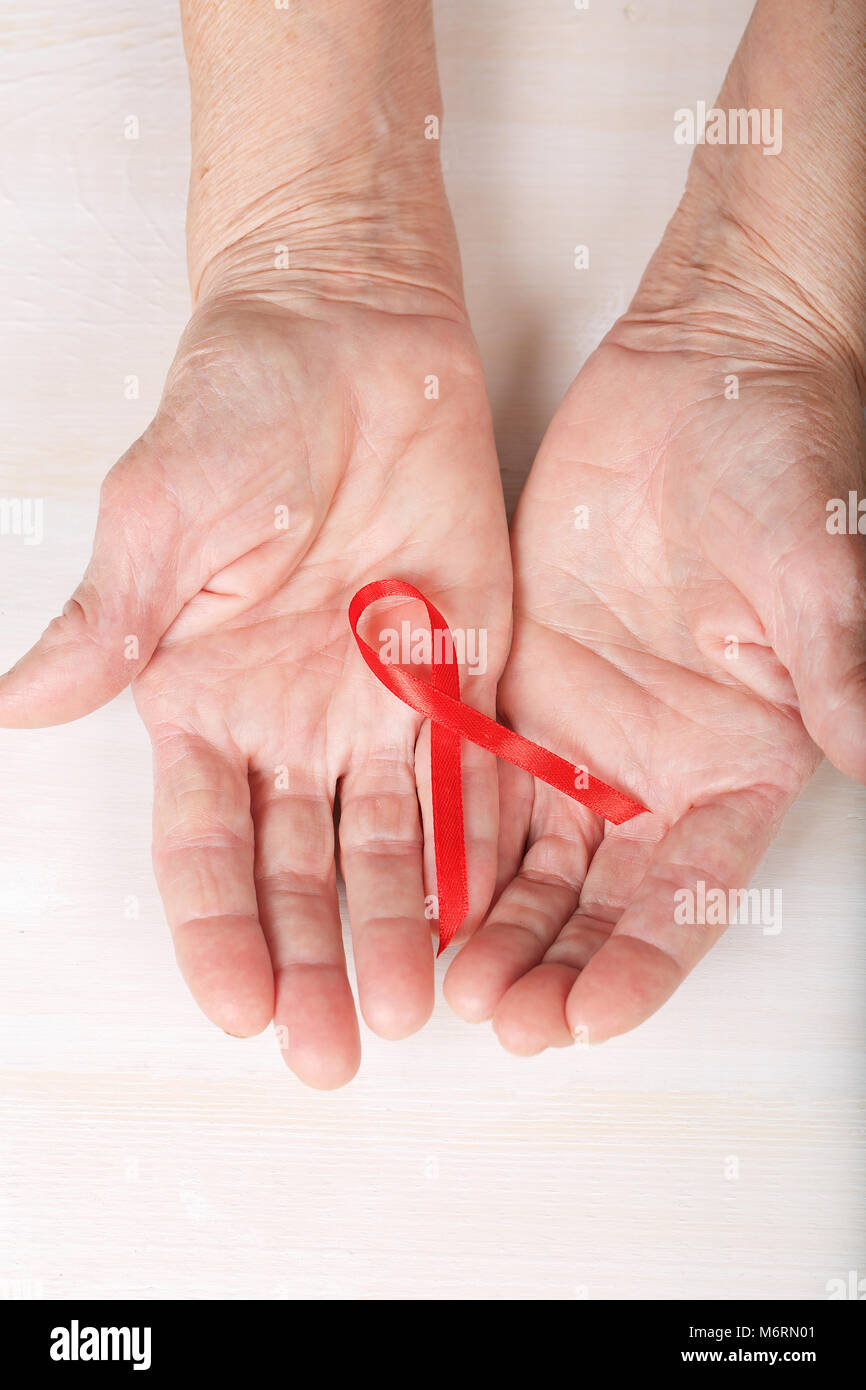 Old woman shows red silk ribbon.Closeup Stock Photo - Alamy