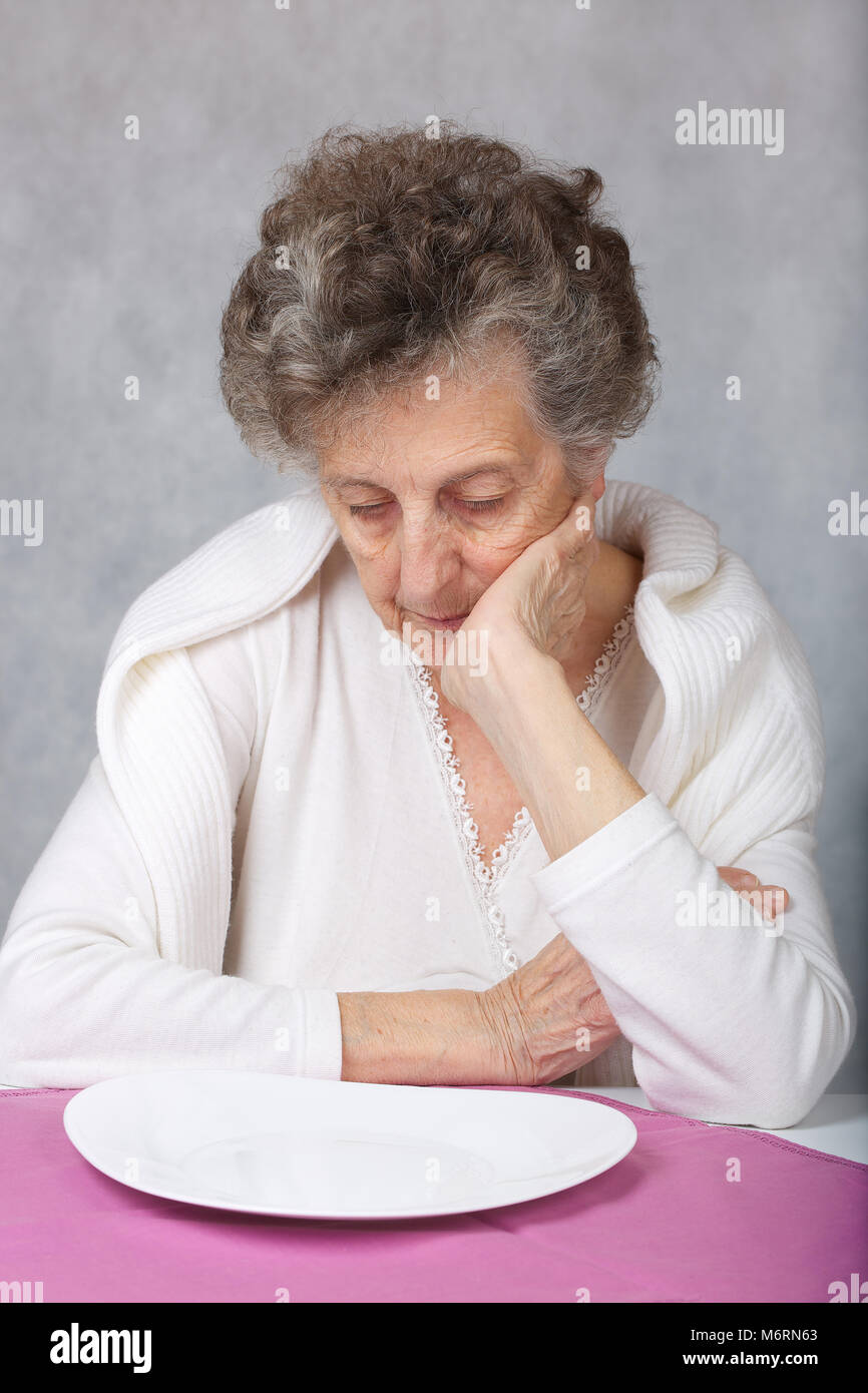 Old woman of 80 years old in front of an empty plate Stock Photo - Alamy