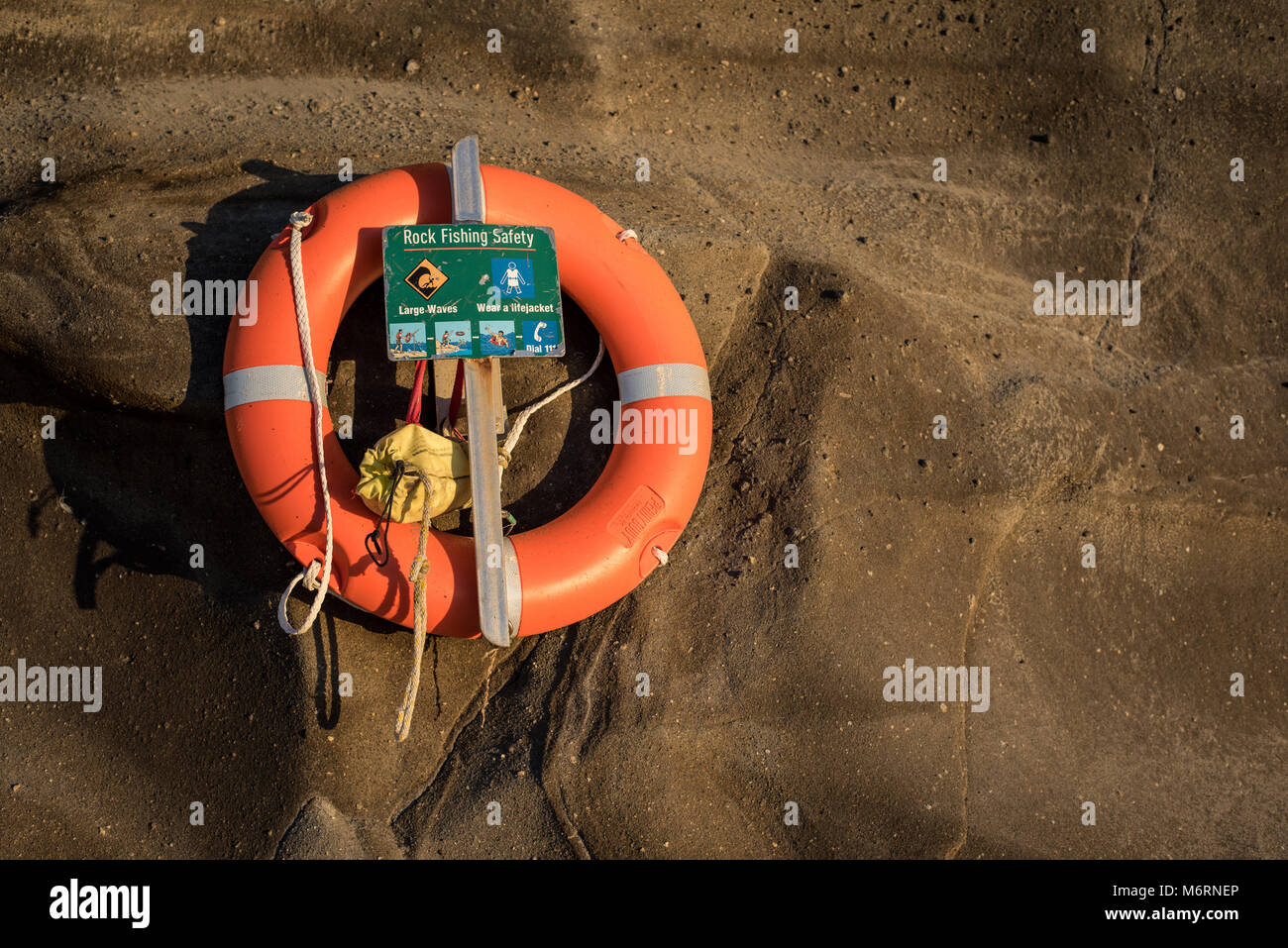 Lifebuoy round from Muriwai beach in sunset Stock Photo - Alamy