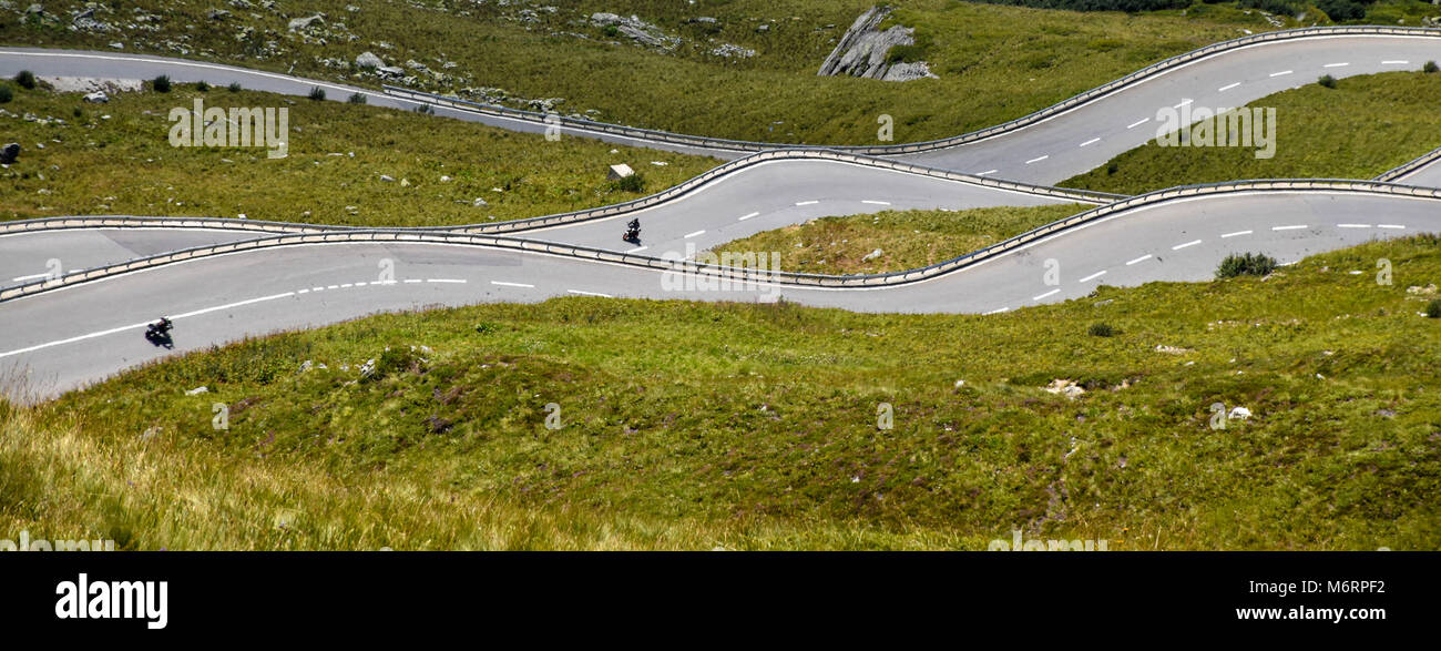 Road curves like waves in the green hills of the Swiss Alps Stock Photo ...