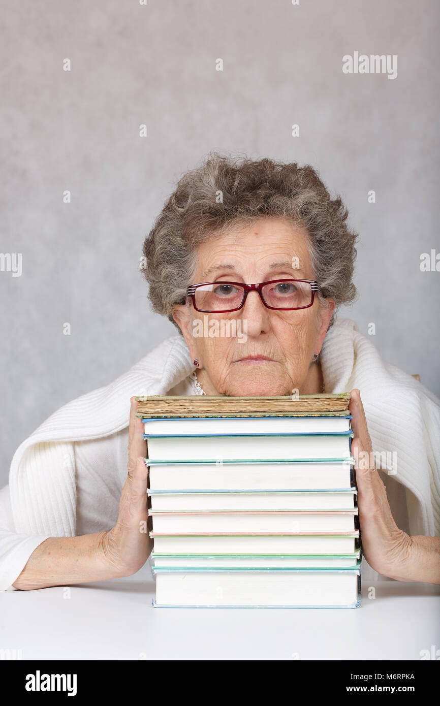 Senior woman pile books hi-res stock photography and images - Alamy