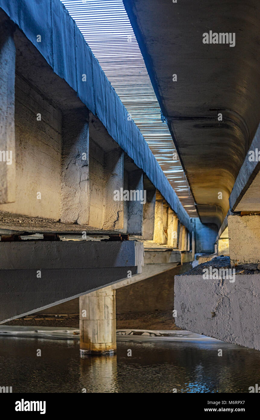 Type of concrete road bridge across the river view from below. Abstract ...