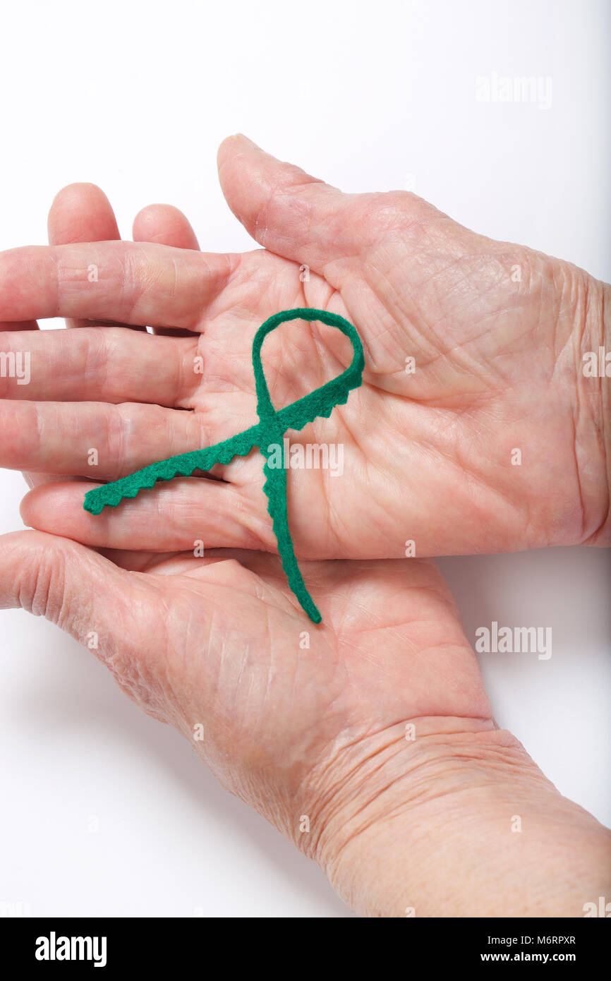 Senior woman keeps a green felt ribbon.Closeup Stock Photo - Alamy