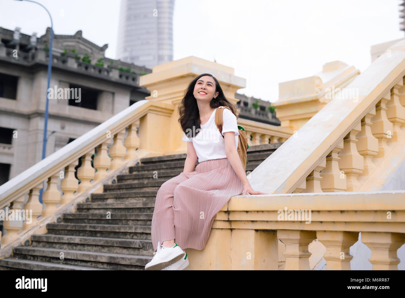 Beautiful asian girl is having a rest outdoors Stock Photo - Alamy