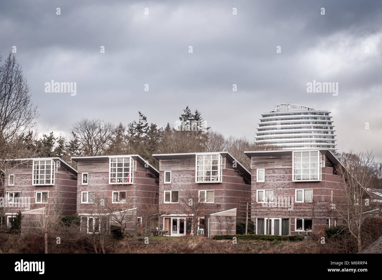 Dutch houses and a high building in the background Stock Photo - Alamy