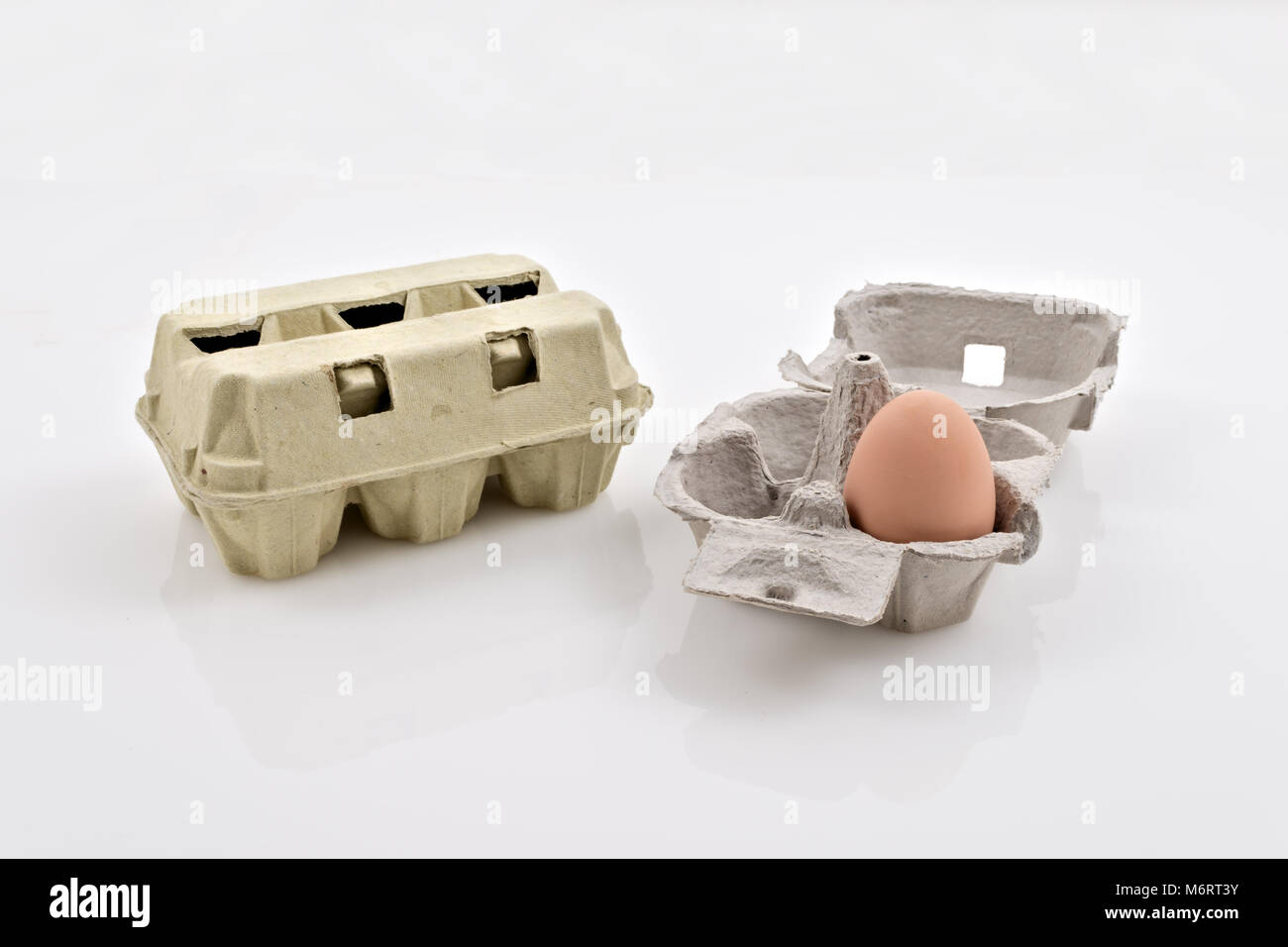empty egg box with egg on white Stock Photo - Alamy