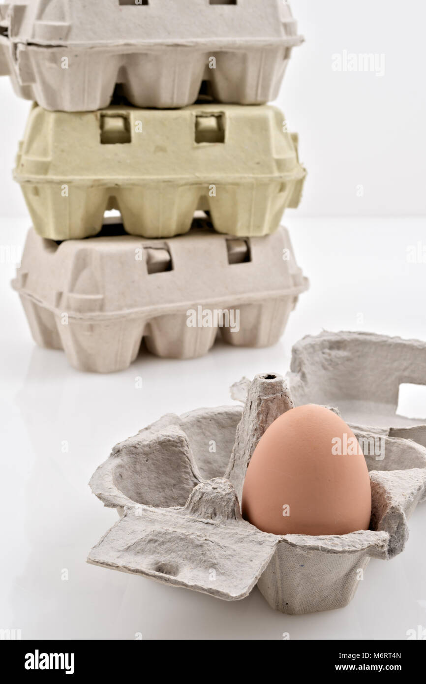 empty egg box with egg on white 4 Stock Photo - Alamy