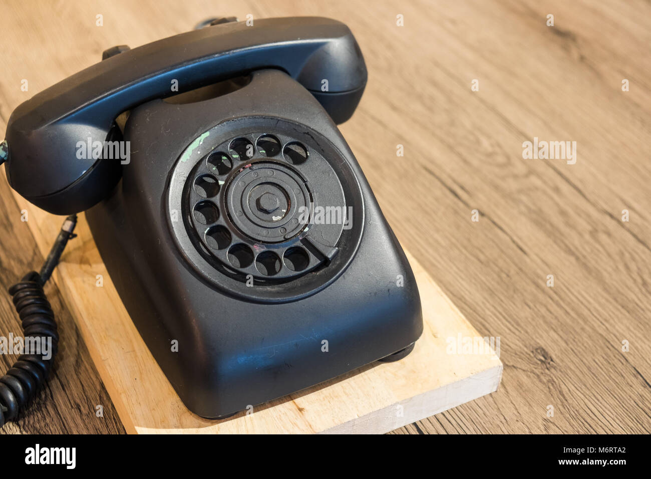 vintage old telephone on wood table Stock Photo - Alamy