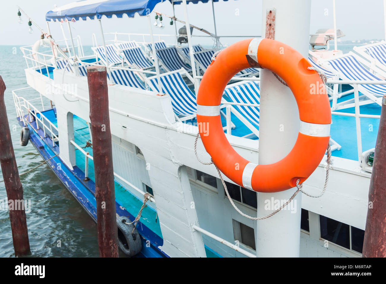 Orange lifebuoy , Safety equipment, at the pier Stock Photo - Alamy