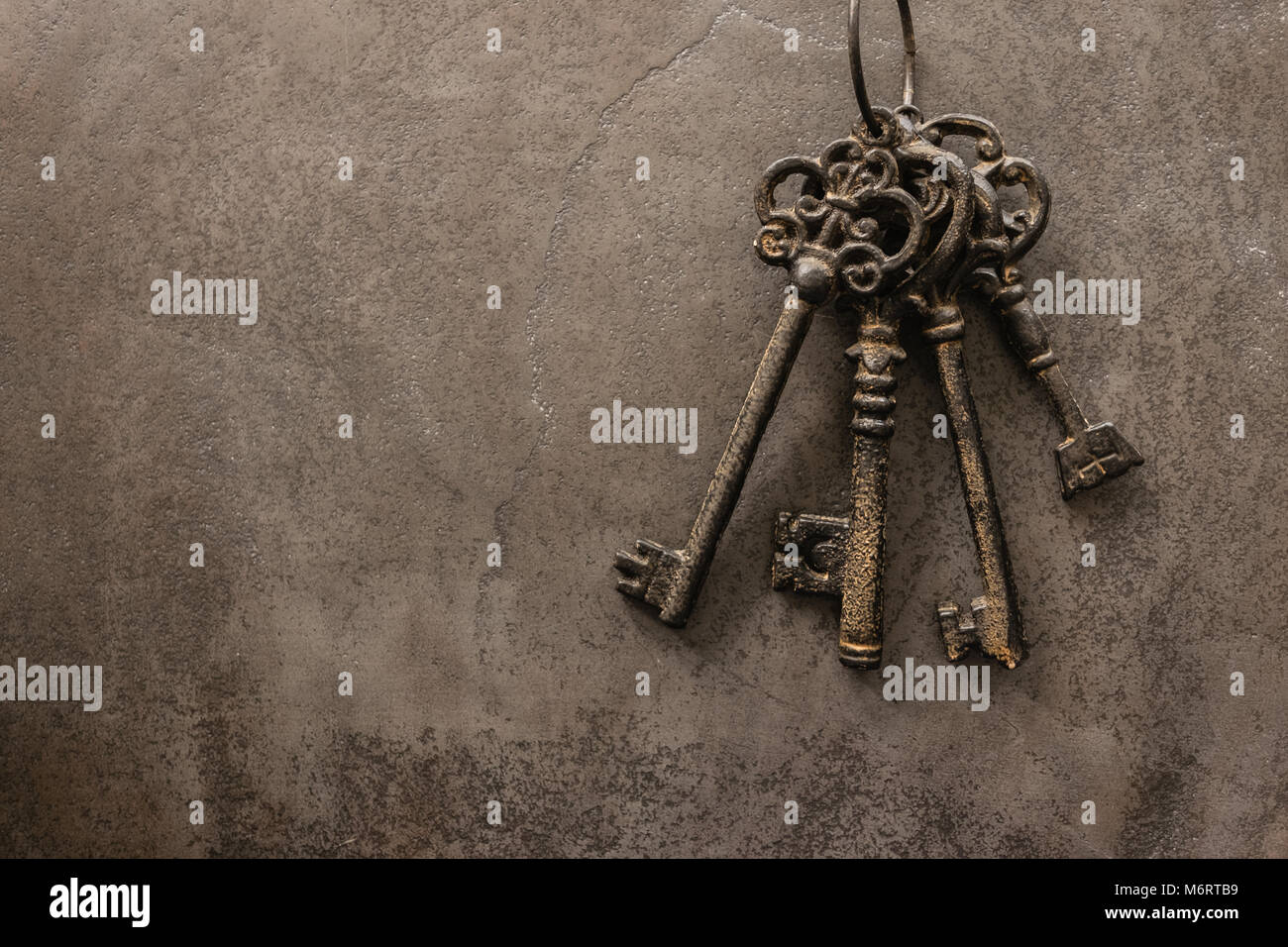 antique keys on old steel metal texture background Stock Photo - Alamy