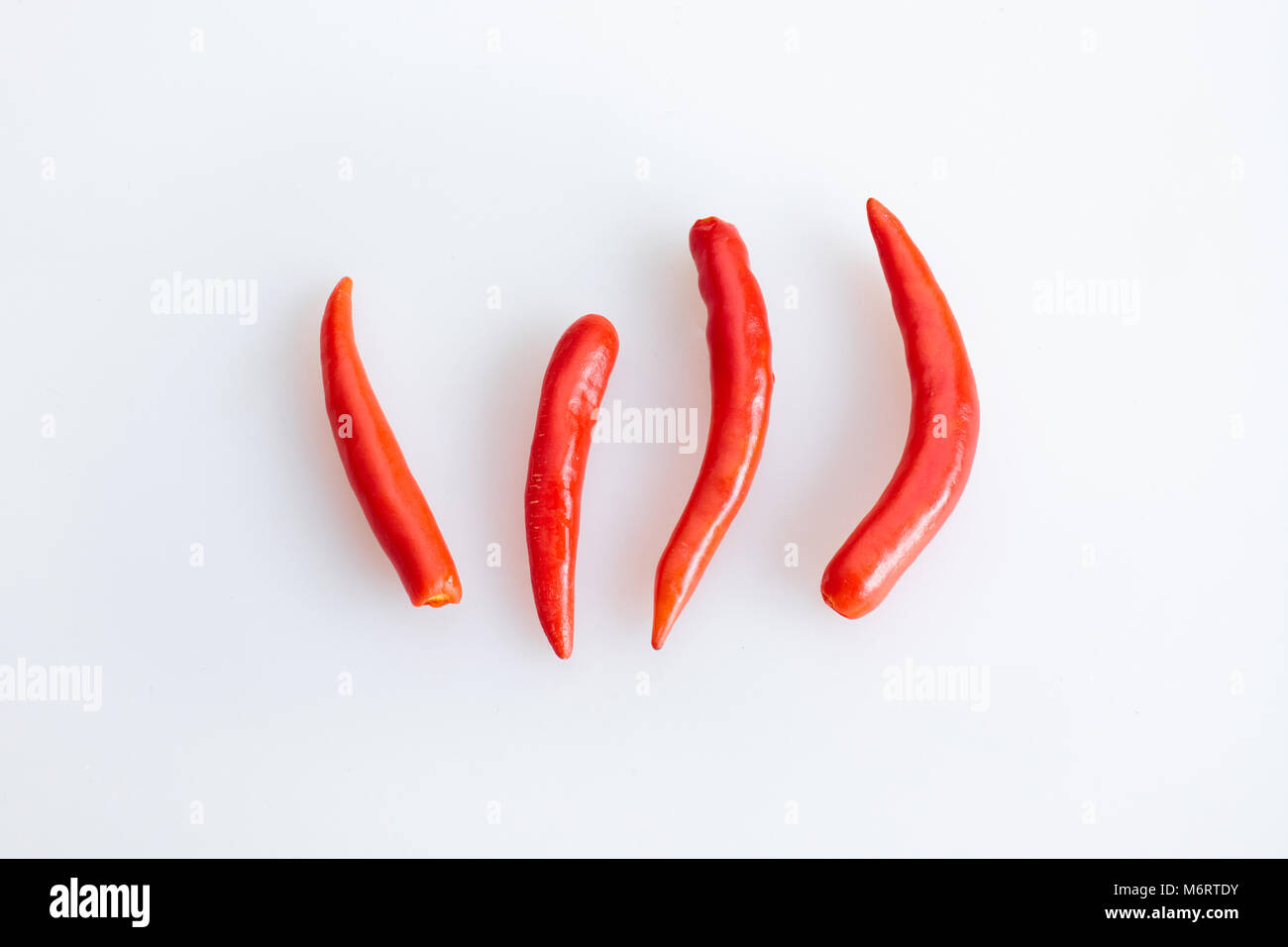 Group of red chilli peppers without stem on white background - top view ...