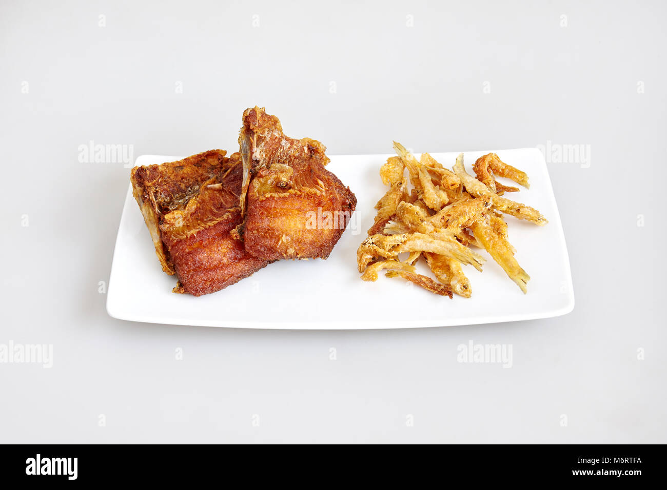 Tilapia fish fried and white bait fish fried - close up, top view Stock ...