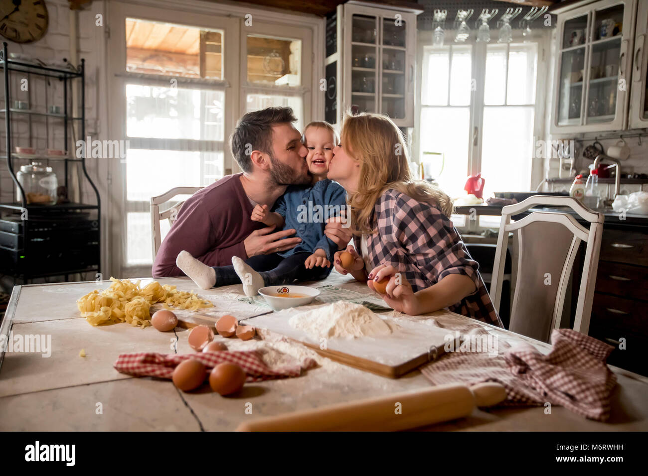 Happy family making pasta in the kitchen at home Stock Photo - Alamy