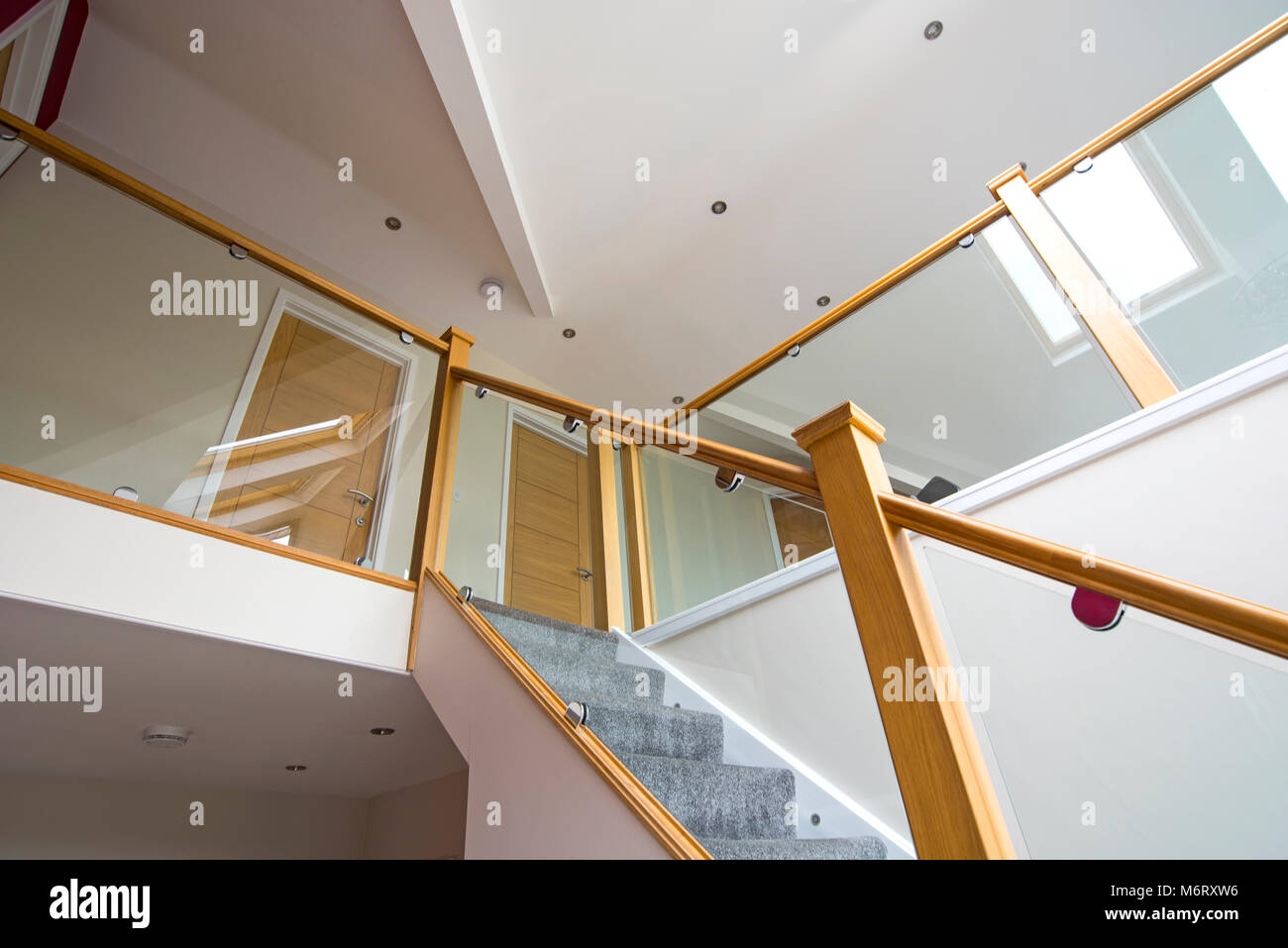 Modern home interior staircase and glass balustrade Stock Photo - Alamy